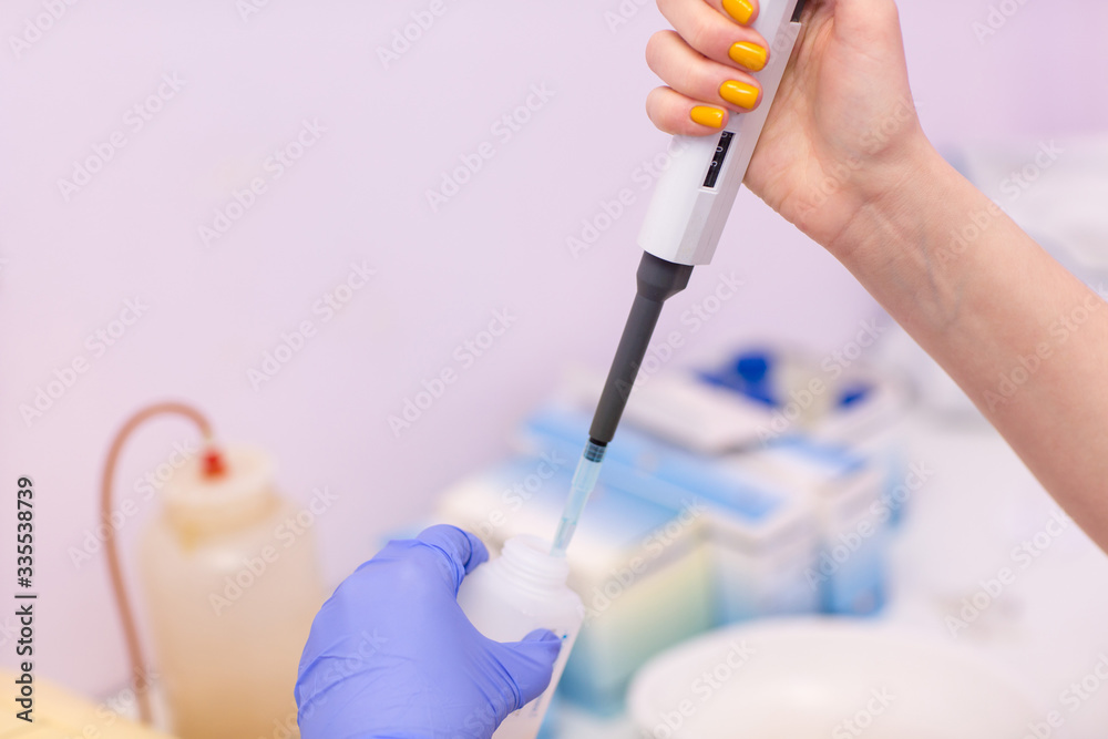 Laboratory assistant in medical laboratory holds test tube with blood ...