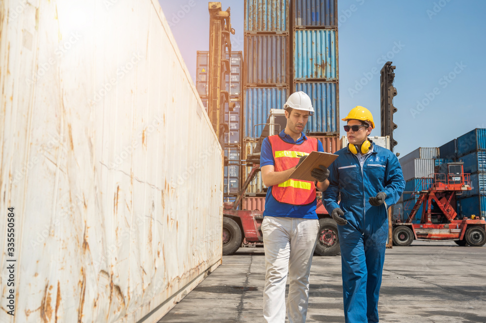Foreman and dock worker staff working checking at Container cargo ...