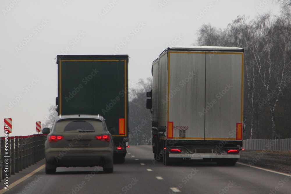 Suburban two-lane highway traffic, slow truck in the left lane make it ...