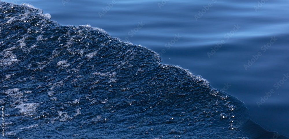 beautiful separation of water into a smooth surface and a storm. Blue ...