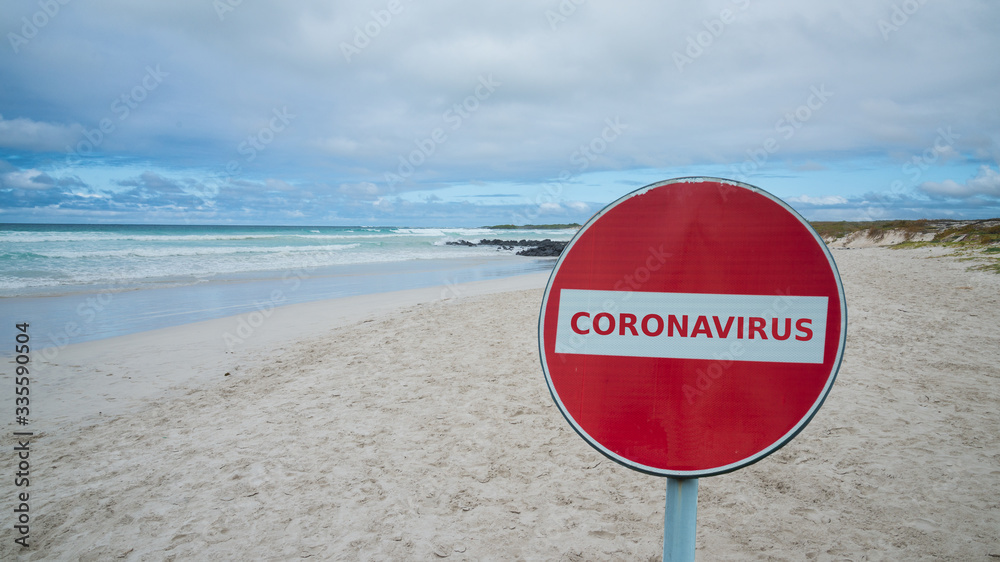 Coronavirus no-entry sign in front of a beach Stock Photo | Adobe Stock