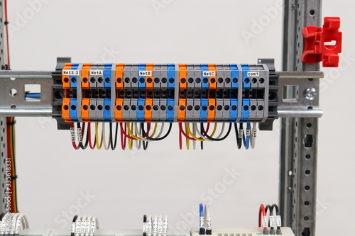 Pass-through electrical terminals for connecting wires in electrical ...