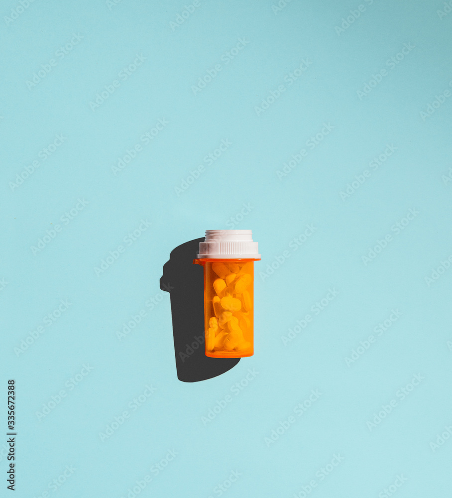 Pill Bottle Casting Shadow on Blue Background Stock Photo | Adobe Stock