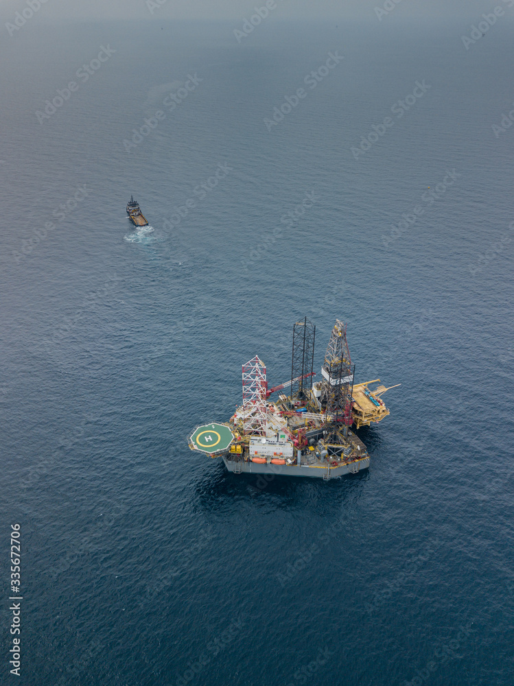 Aerial view offshore jack up rig and a tow vessel at the offshore ...
