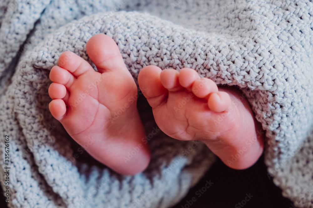 Little sweet feet of newborn baby wrapped in a blanket. Stock Photo ...