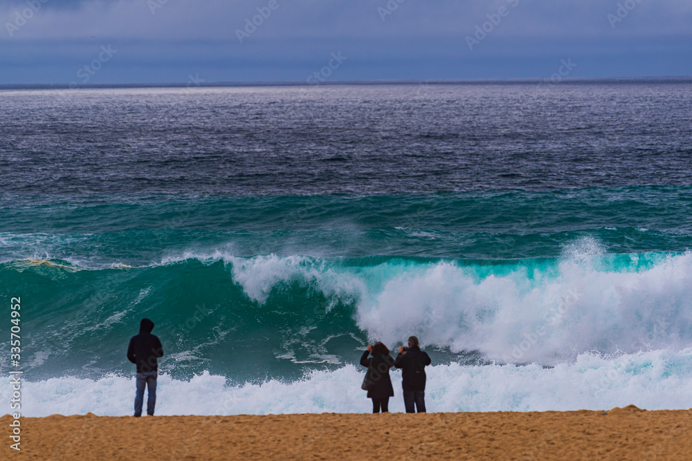 Giant breaking waves along the beach -Nazare North Beach, Portugal is ...