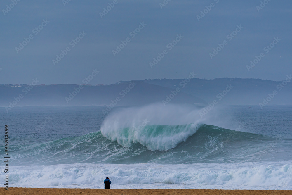 Giant breaking waves along the beach -Nazare North Beach, Portugal is ...