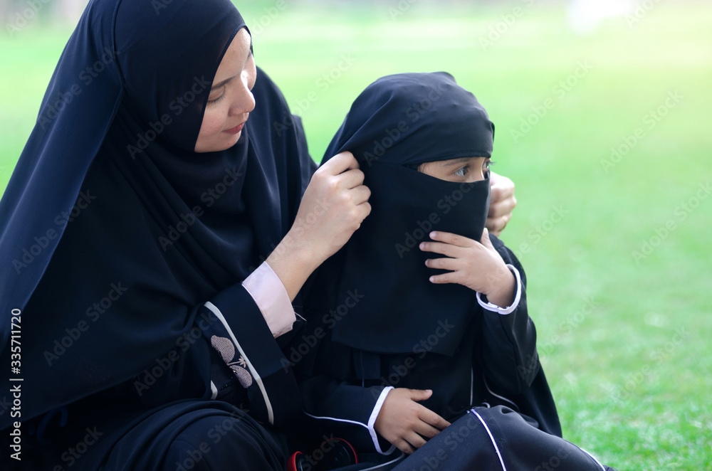 Muslim family mom and daughter in hijabs and traditional clothes ...