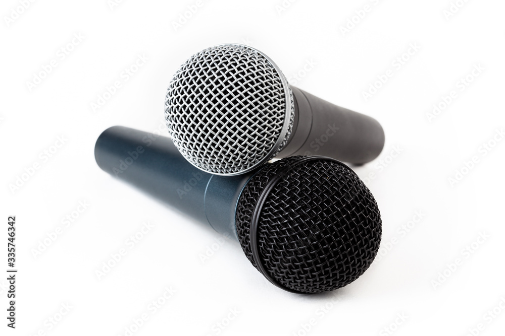 Two microphones laying on top of each other, pair of singing mics ...