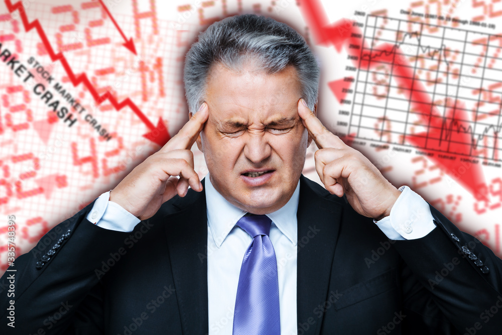 Stock market crash. Stressed investor keeping eyes closed and feeling ...