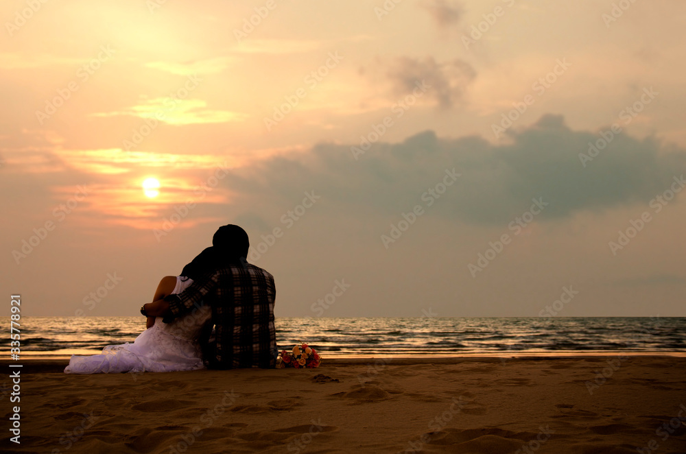 Couple in love watching sunset together on beach travel summer holiday ...