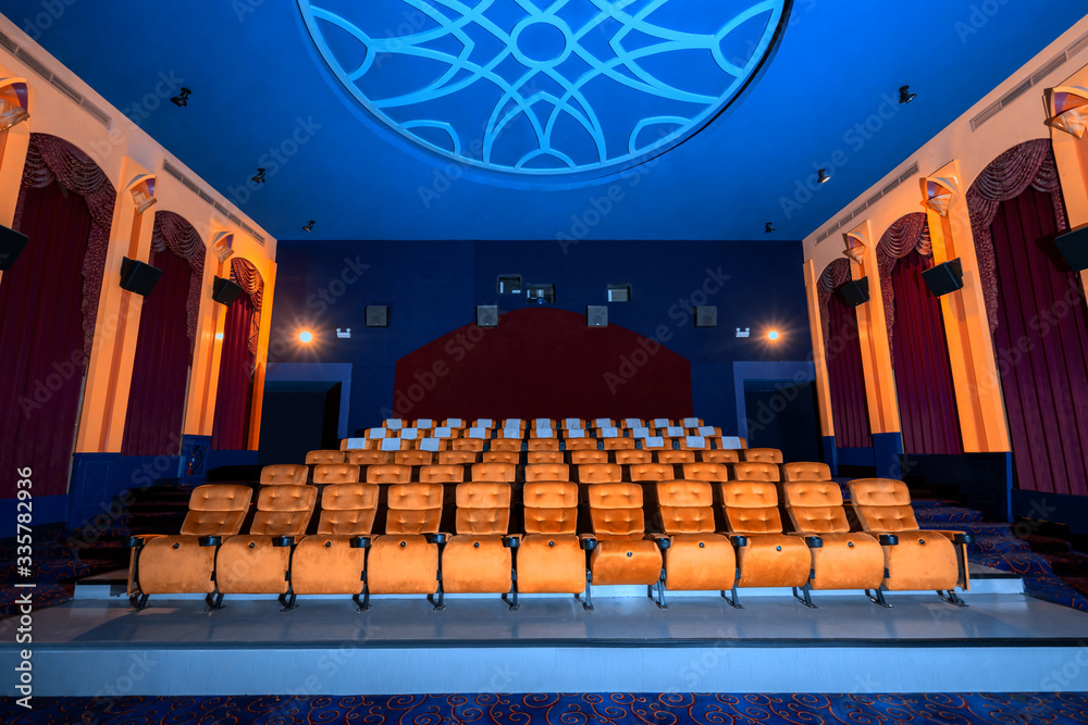 Large cinema theater interior with seat rows for audience to sit in ...