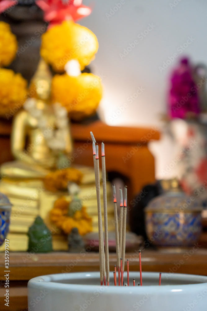 An incense burner with lit incense sticks used for worship is placed in ...