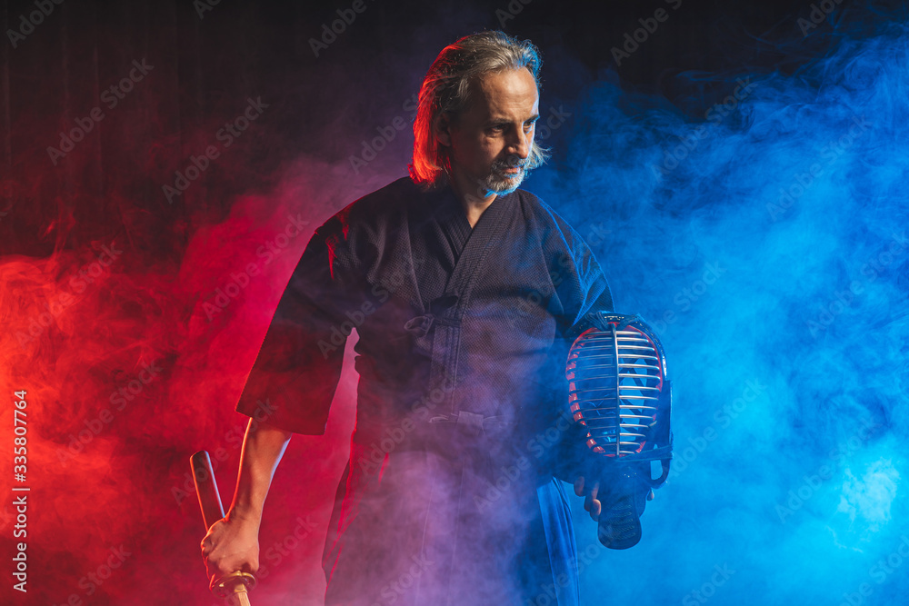 strong caucasian kendo fighter in traditional clothes. japanese martial ...