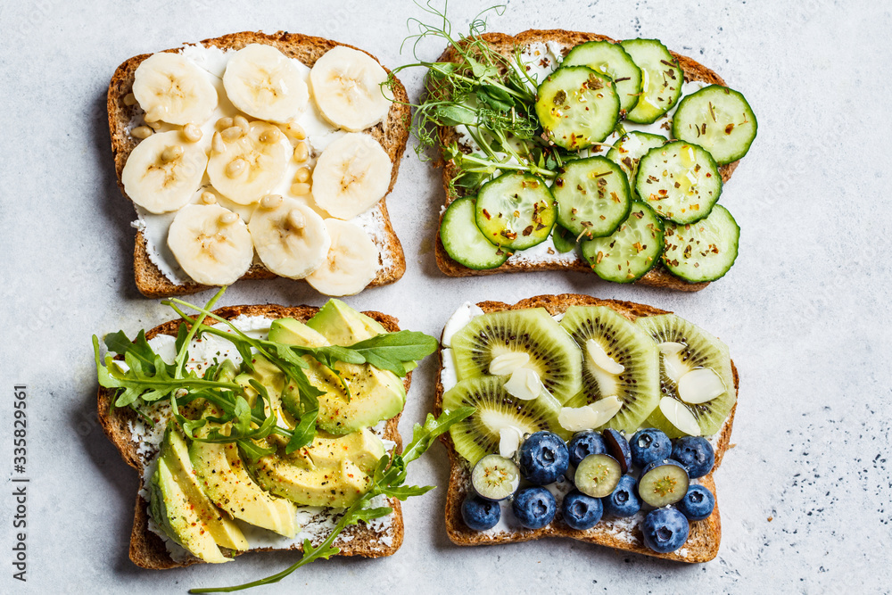 Breakfast toasts with various healthy toppings. Sandwiches with cream ...