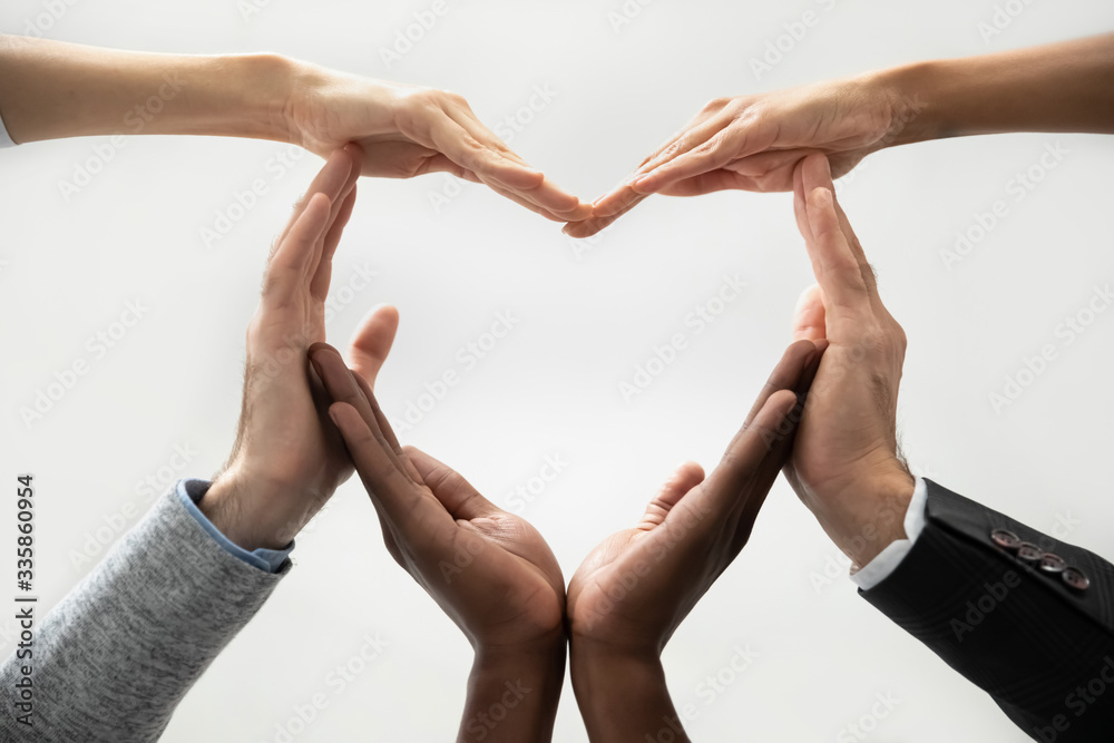 Close up bottom view concept of diverse business people join hands ...