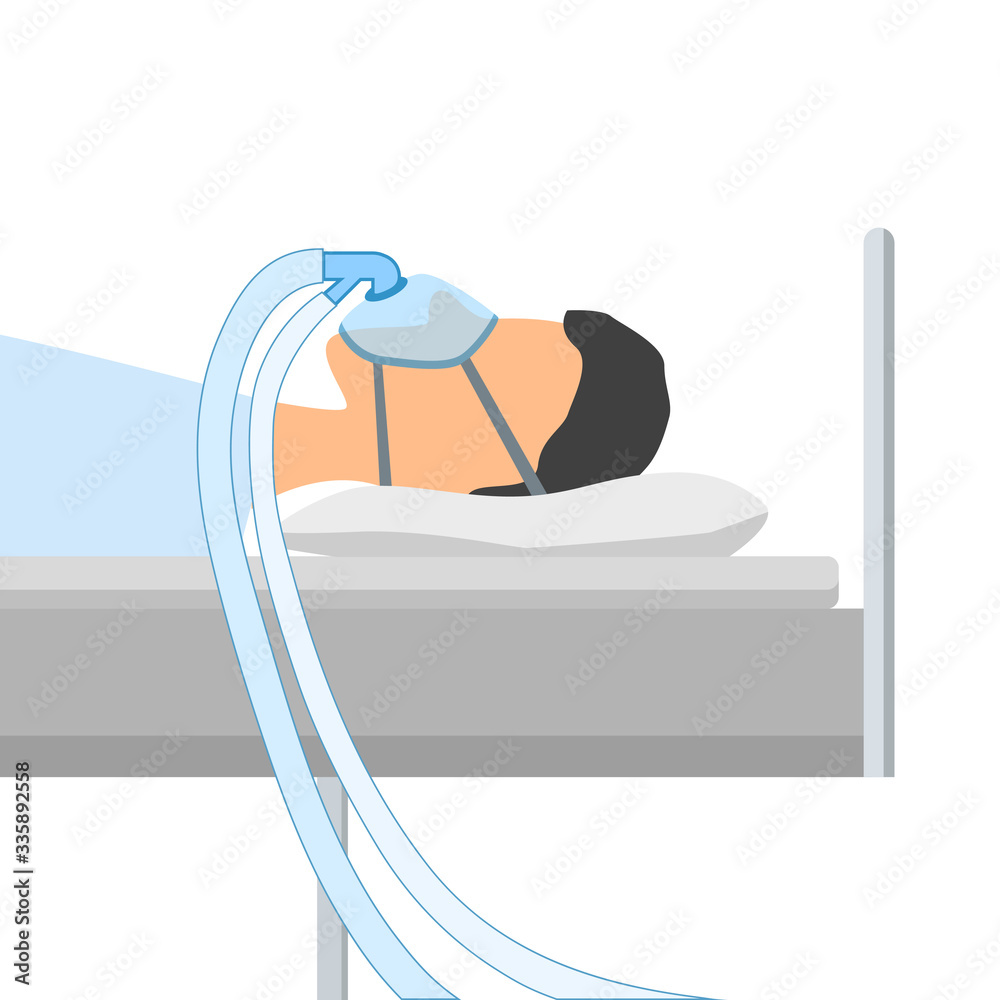 A man lies on a bed with a mask for artificial ventilation of the lungs ...
