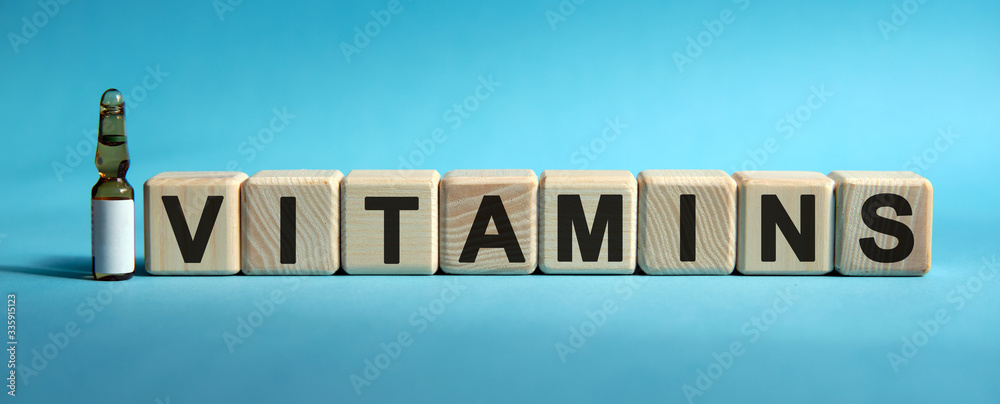 VITAMINS - text on cubes. Drug in ambula to reduce disease symptoms on ...