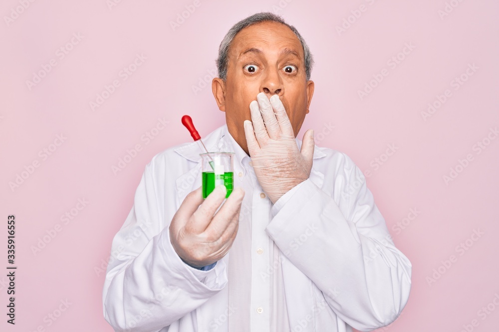 Senior grey-haired scientist man wearing holding sample tube test over ...