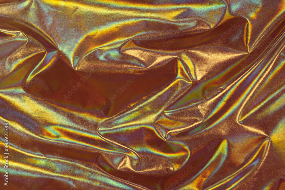Yellow-orange hue shiny crumpled fabric, iridescent rainbow fabric ...