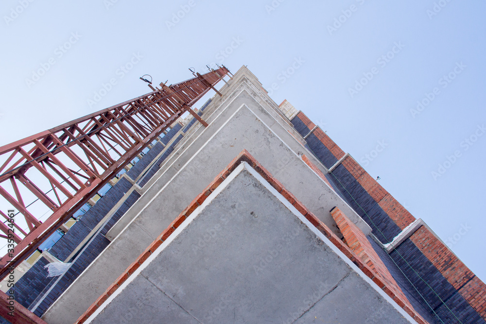 Concrete base of the building and brickwork during construction foto de ...