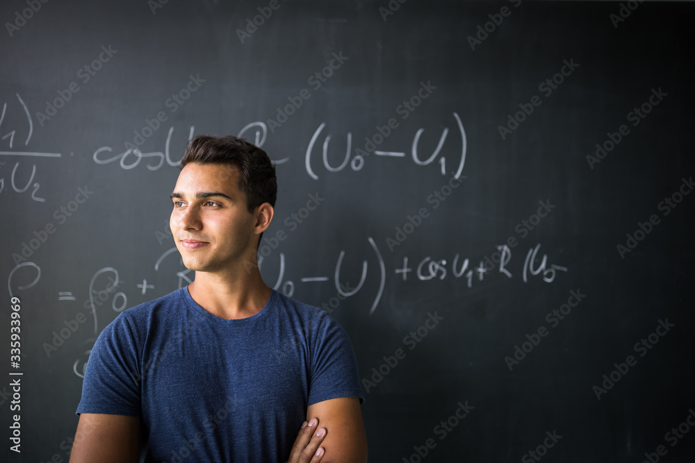 Students in a classroom - handsome student solving a math problem on a ...