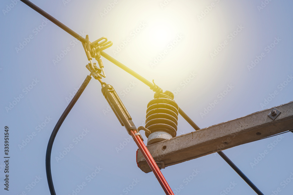 The power lineman uses insutated tool to open the connection of the ...