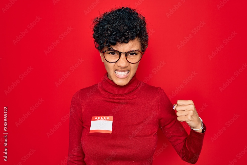 Young beautiful african american afro woman using sticker with ...