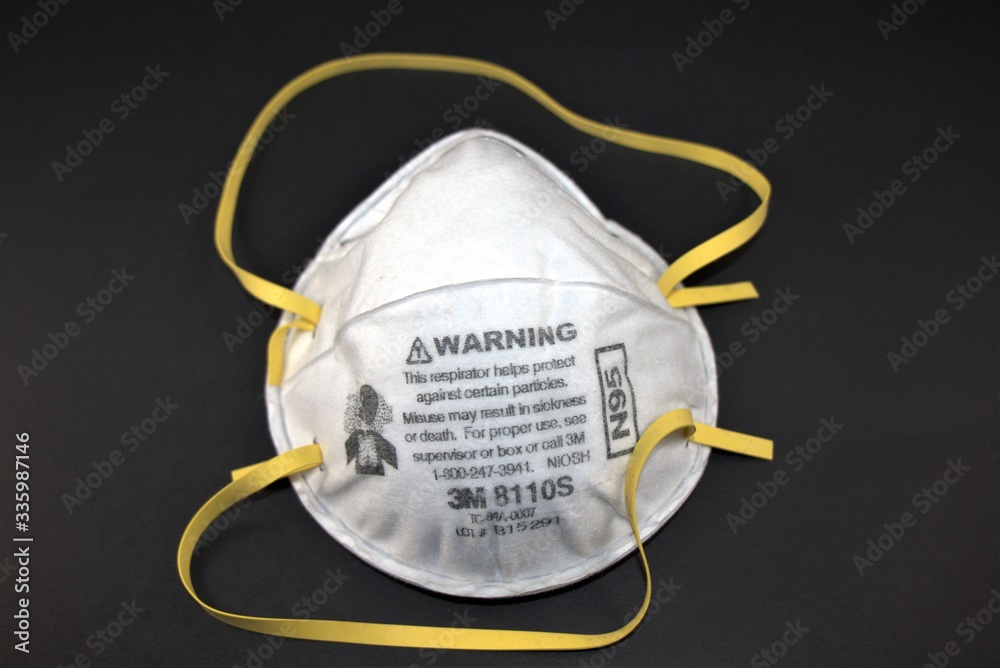 N95 Respirator(face mask) with slings isolated on black background ...