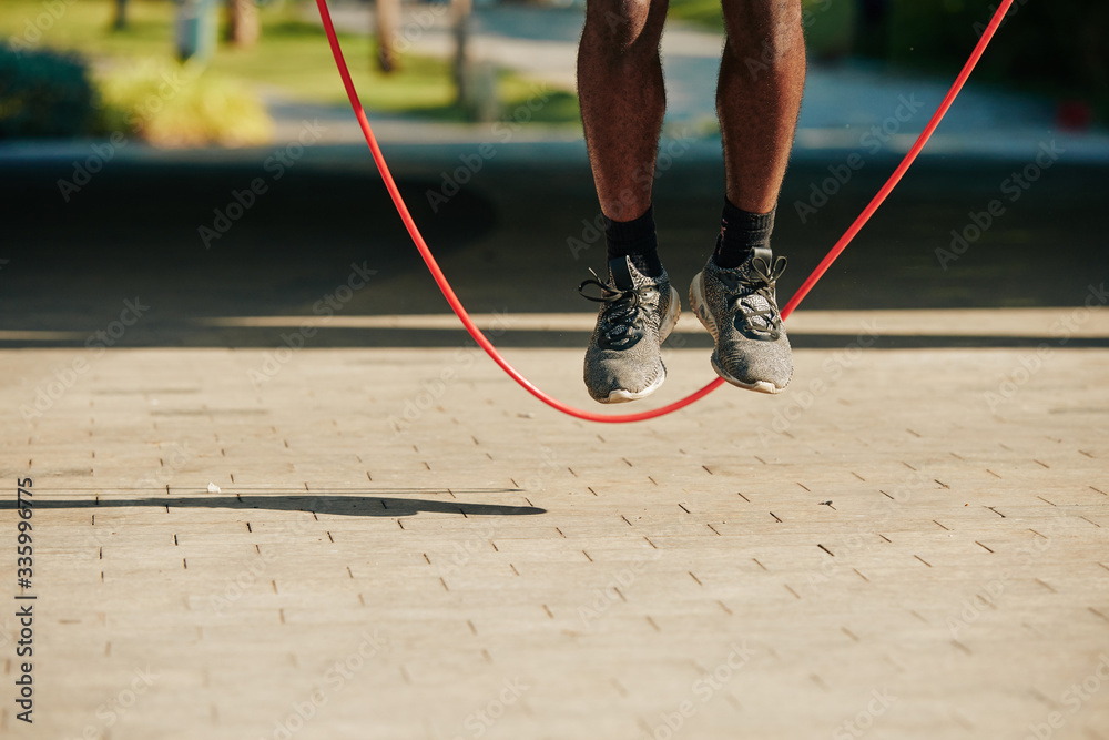 Feet of sportsman jumping with skipping rope Stock Photo | Adobe Stock