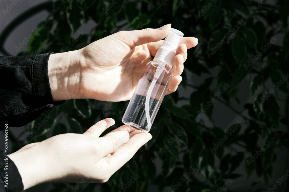 Hand of woman and spray of alcohol antiseptic to make cleaning and ...