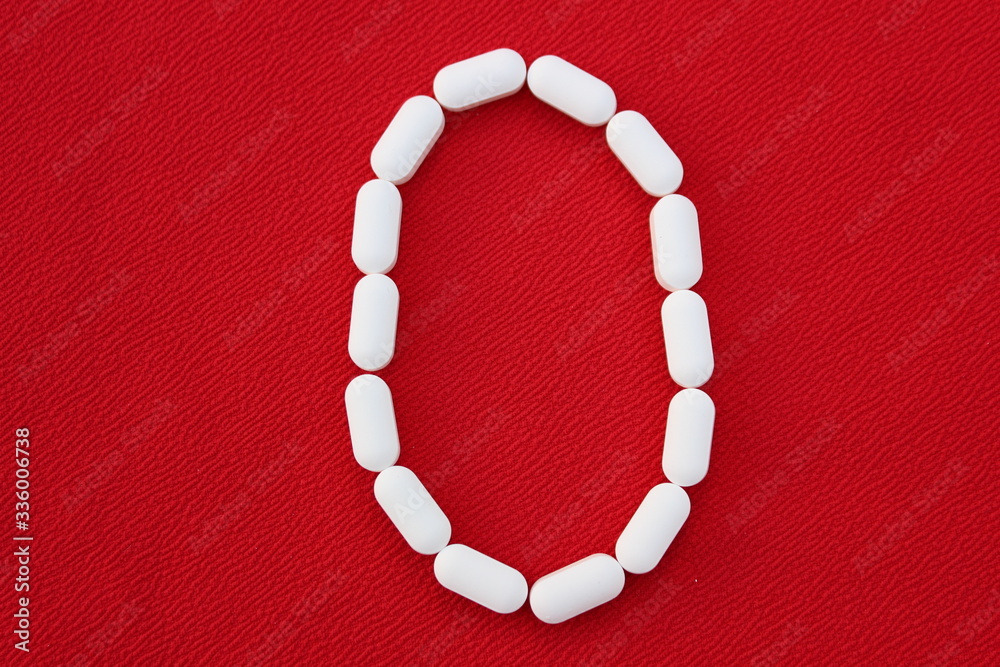Alphabet made of pills on a red background. Abc from drugs. Letter O ...