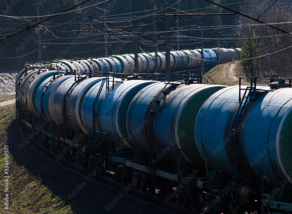 Freight train with petroleum tank cars on railroad. Rail cars carry oil ...