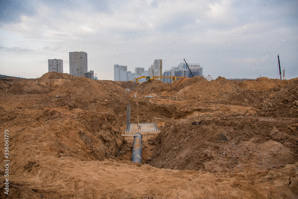 Photo & Art Print Excavator at construction site during laying sewer ...