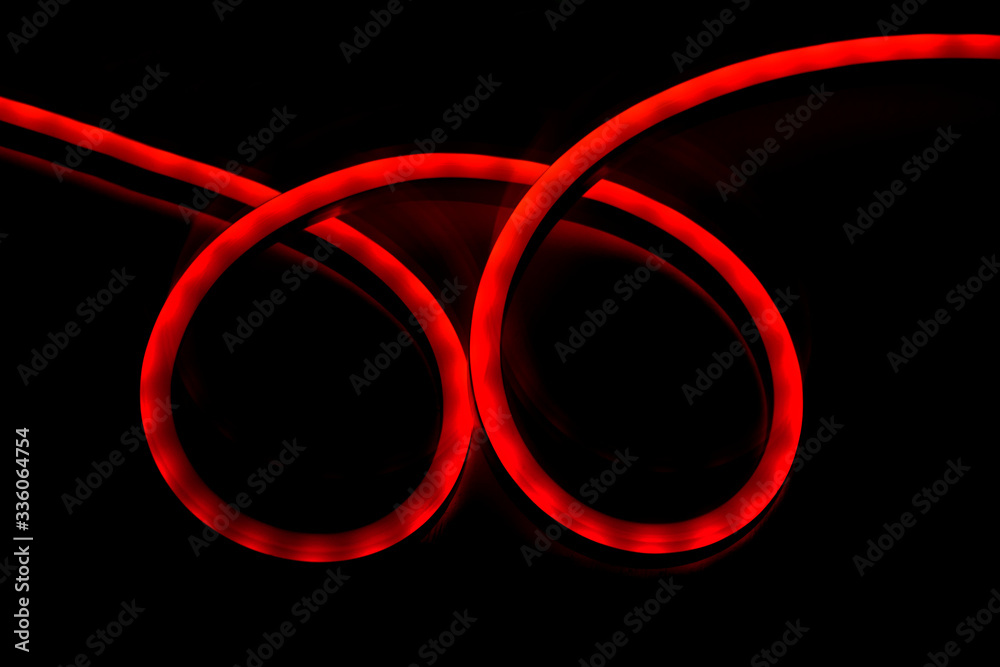 Red LED light diode stripe cable roll on black background. Modern ...