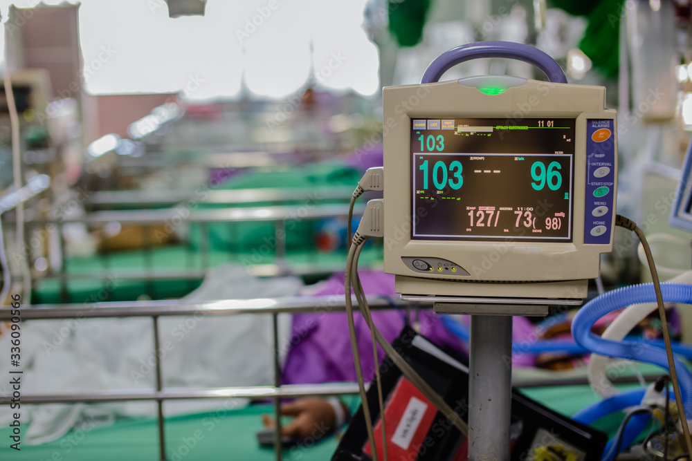 Modern vital sign monitor on patient background at ward in the hospital ...