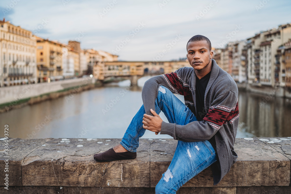 Portrait of young man in front of Ponte Vecchio, Florence - Millennial ...