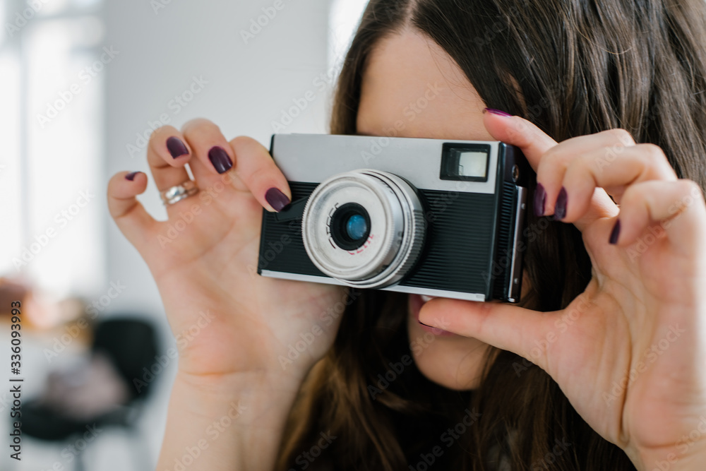 beautiful woman holding old camera at home Stock Photo | Adobe Stock