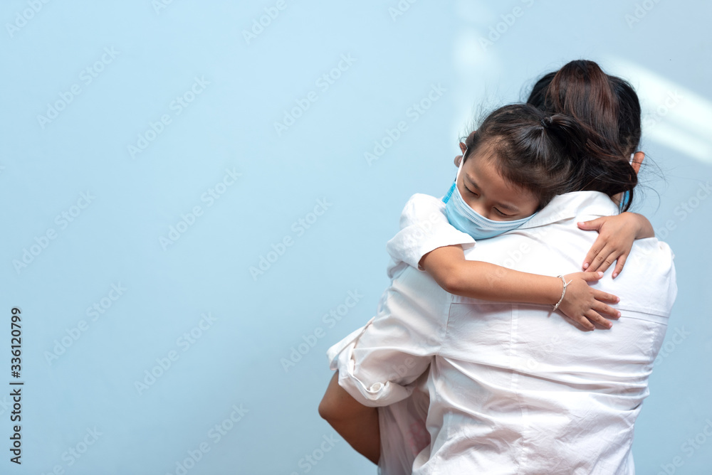 Asian mothers and young children wear medical masks to protect themselves from pollution ...