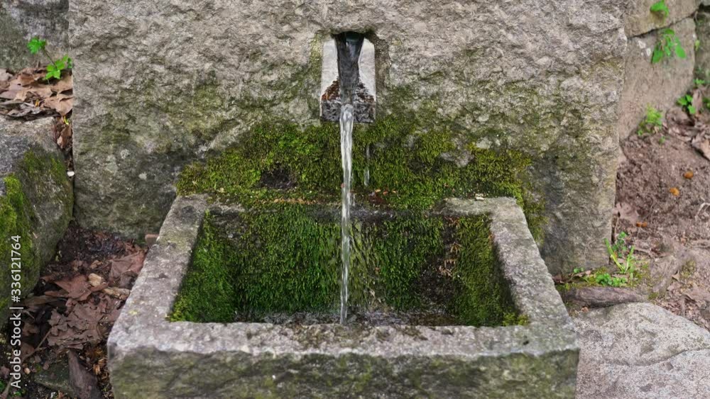 The source of pure spring mineral alkaline water from a stone stack ...