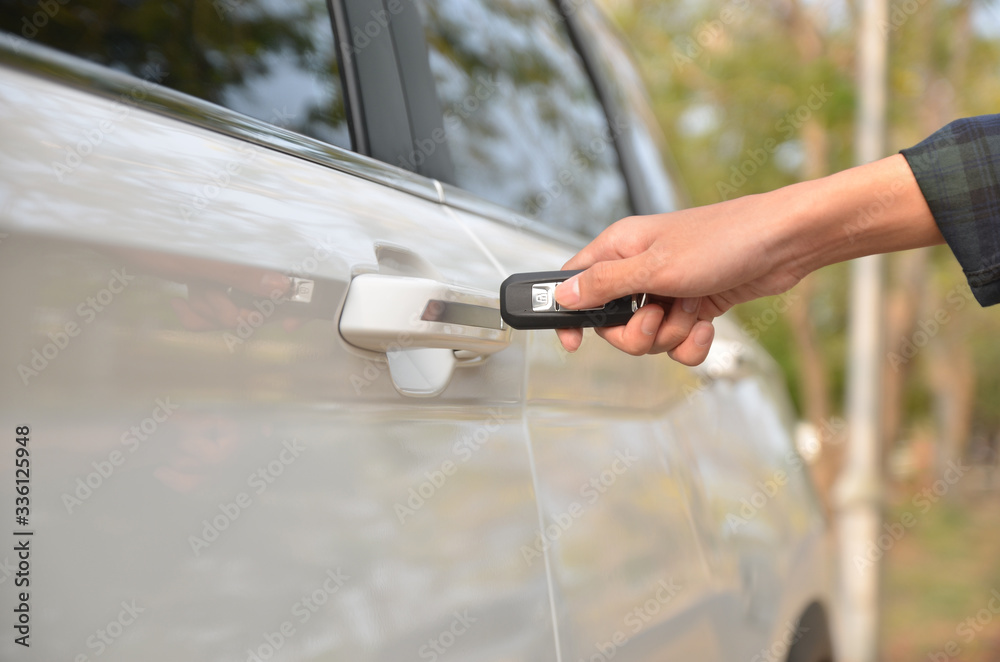 Car remote control by smart key, Hand holding smart key to lock doors ...