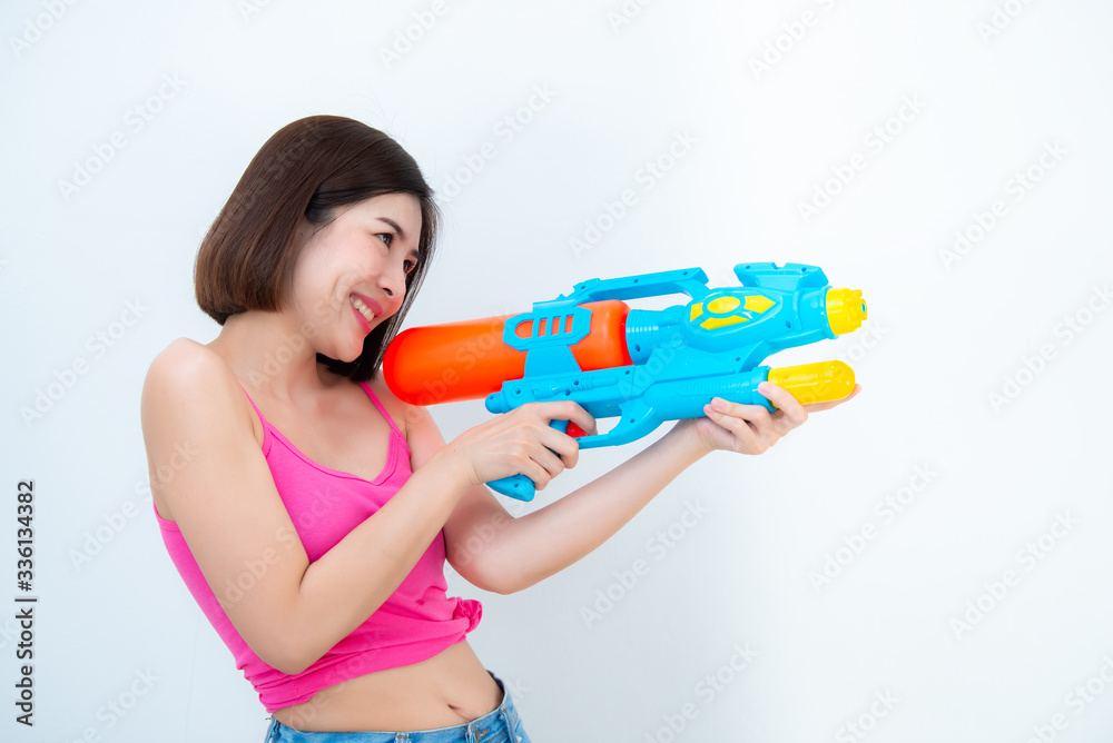 Asian sexy woman with gun water in hand on white background,Festival songkran day at thailand ...