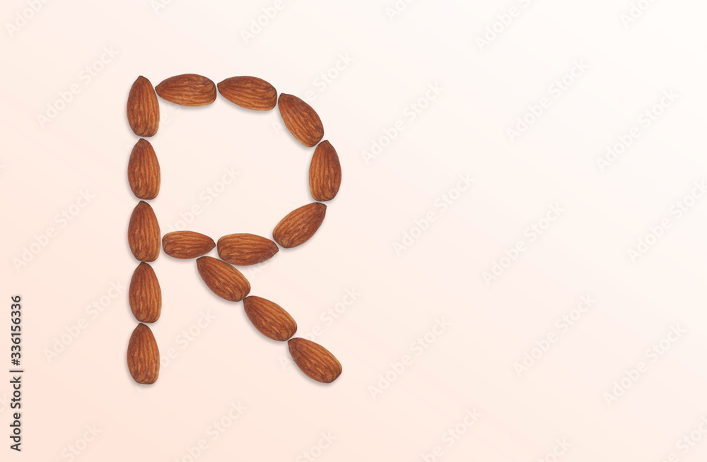 Letter R of the English alphabet from nuts. Food pattern made from nuts ...