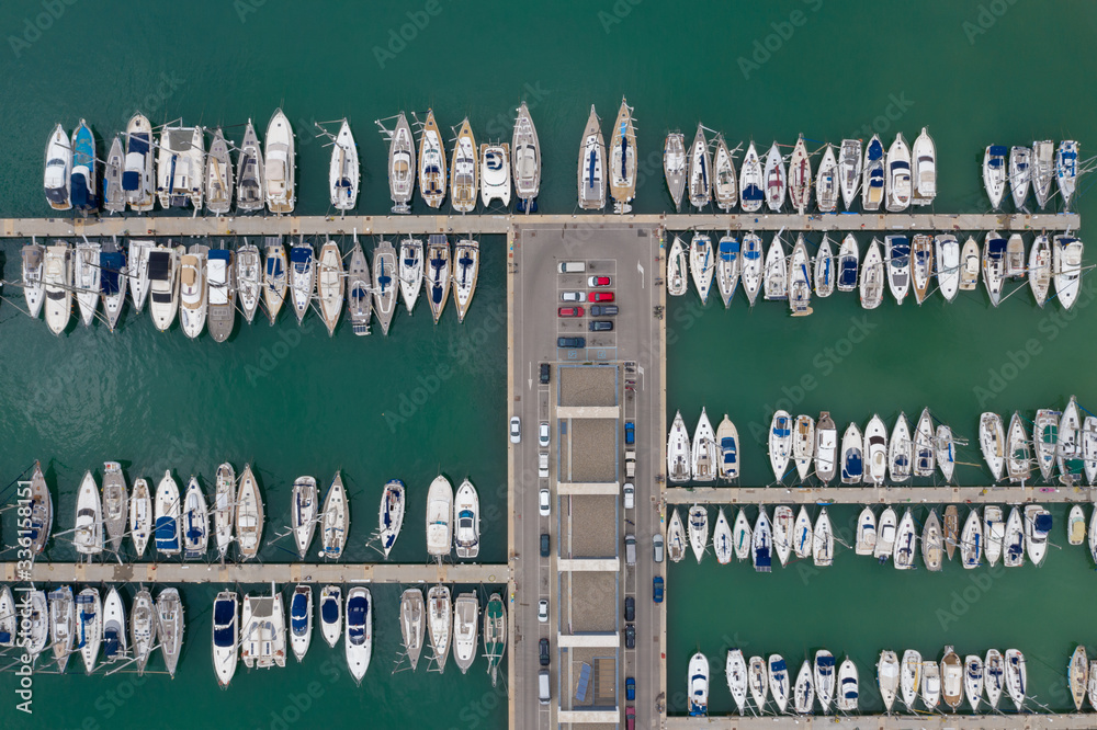Aerial top-down photo of marina a dock basin with moorings and supplies ...
