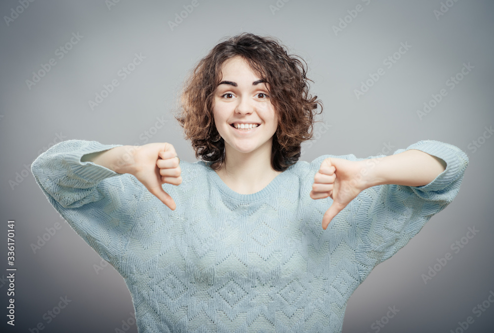 Closeup portrait mad young woman, showing loser sign, giving thumbs ...