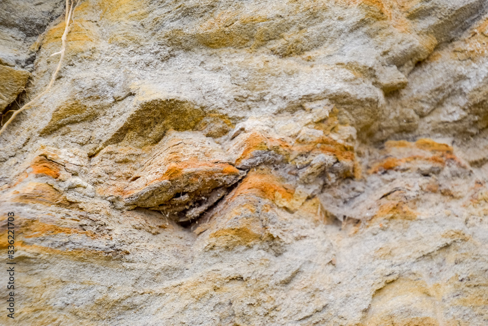 sedimentary layers of the rock in the sand scree. sand, pebbles and ...