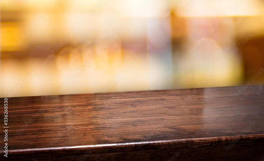 nightclub background.Empty diagonal brown wooden table with blur bar ...