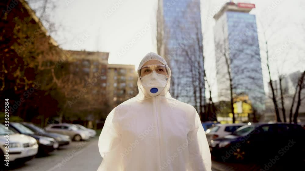 COVID-19 coronavirus doctor walking in hazmat suit.Infectious disease ...