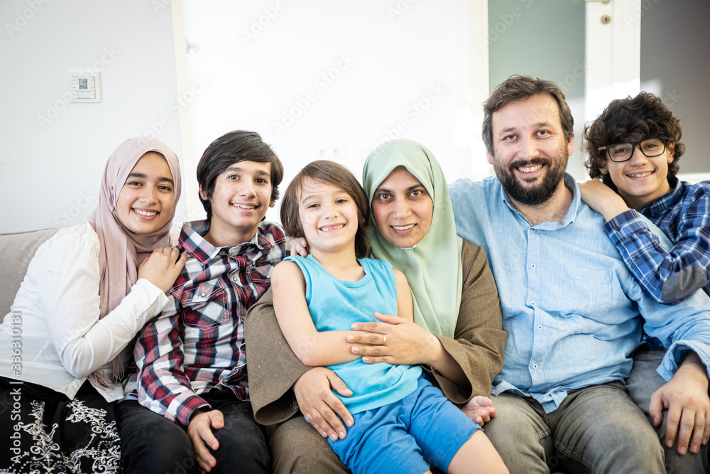 Happy Muslim family portrait on sofa Stock Photo | Adobe Stock