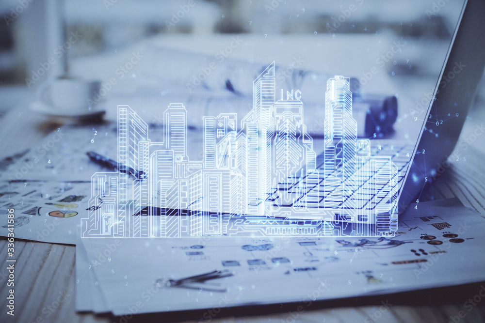 Desktop computer background in office and big town buildings hologram ...